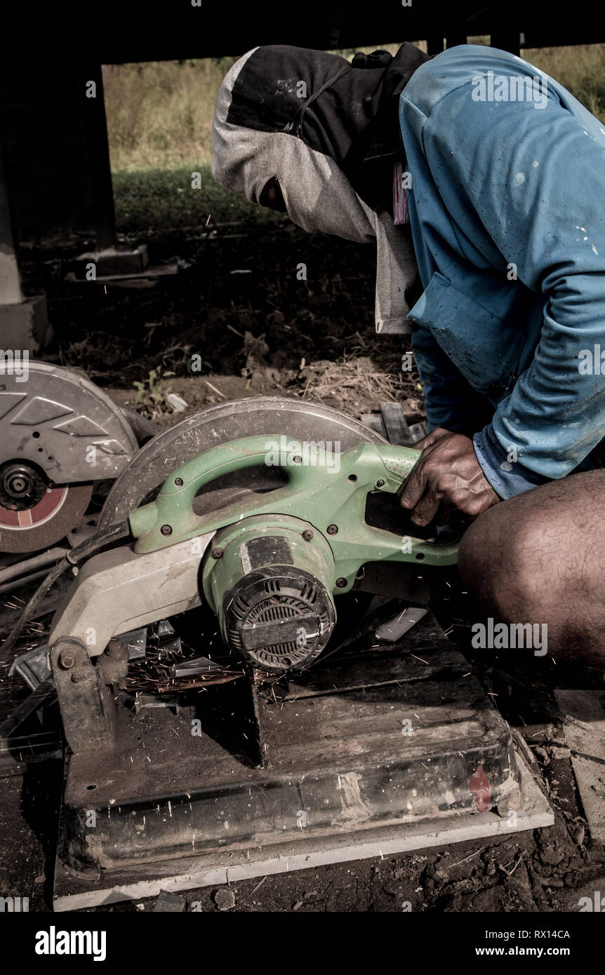 Male worker cutting steel with a cutting machine Stock Photo - Alamy