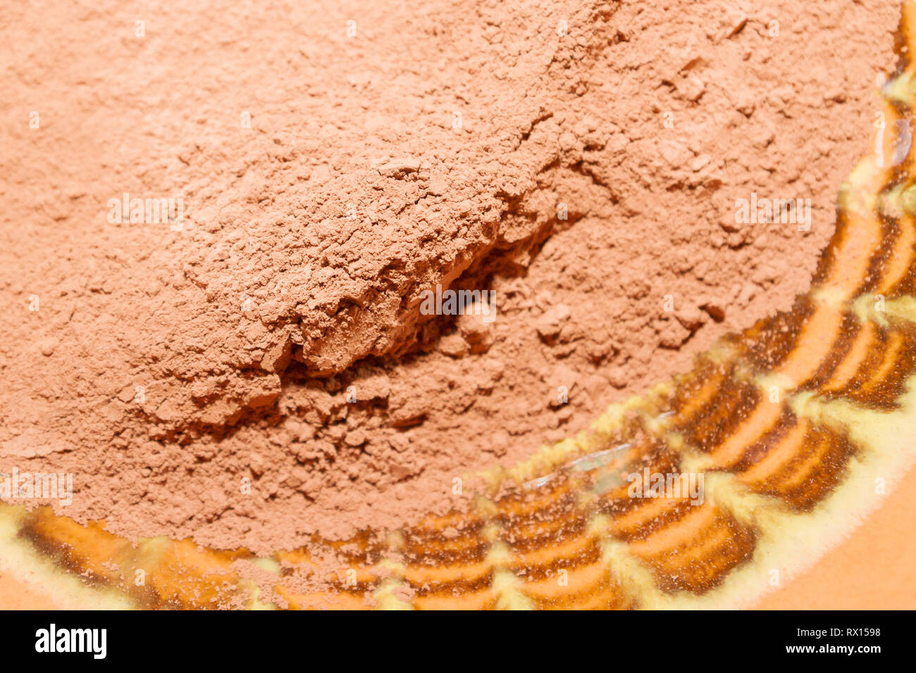 Dry cocoa powder poured into a brown ceramic plate Stock Photo - Alamy