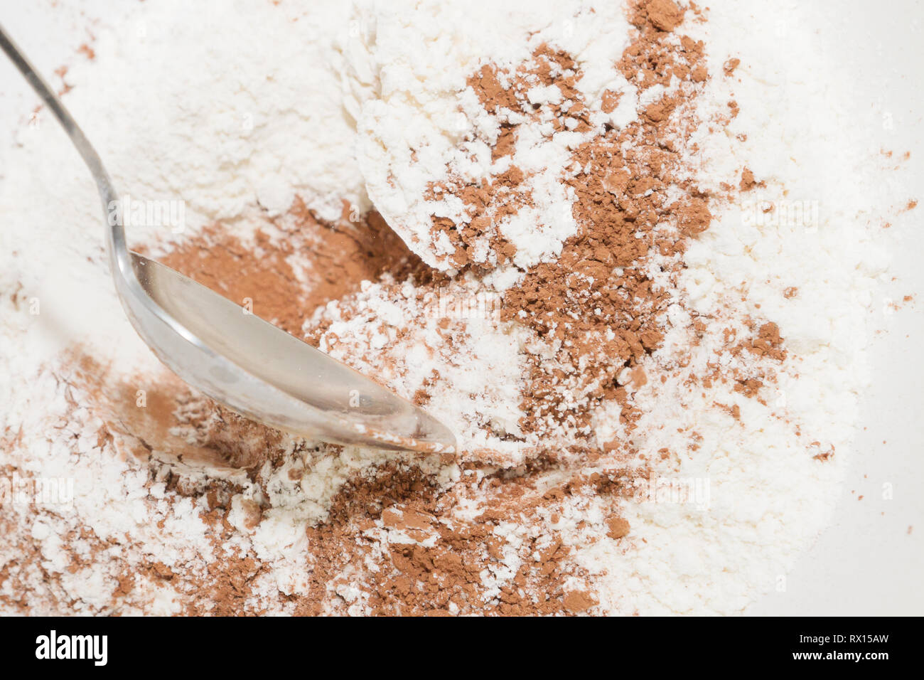 The flour is mixed with dry cocoa powder in a mixing bowl Stock Photo ...