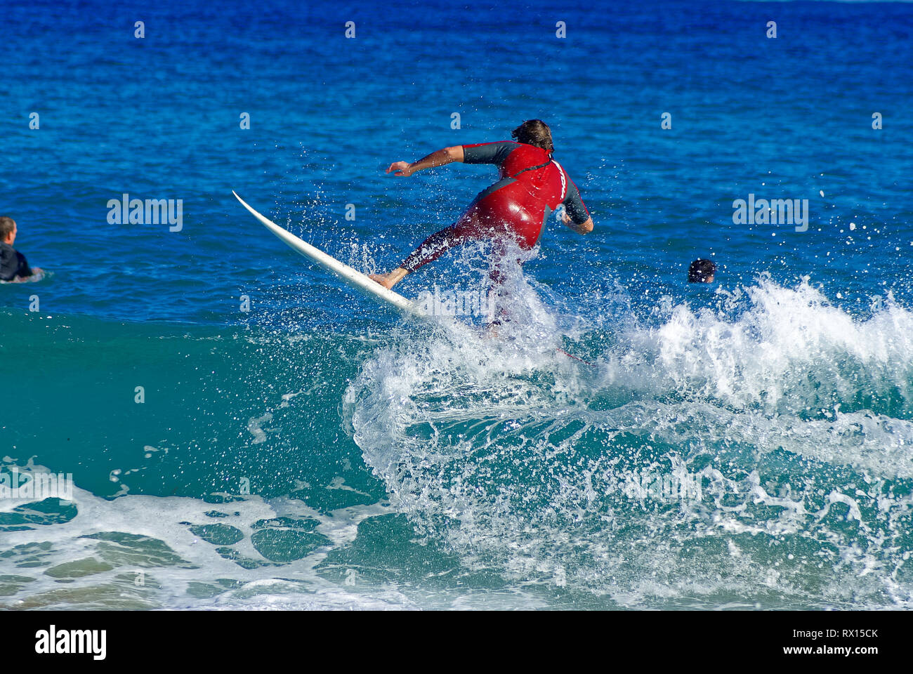 Surfer in red wet suit surfing on the crest of wave in mediterranean ...