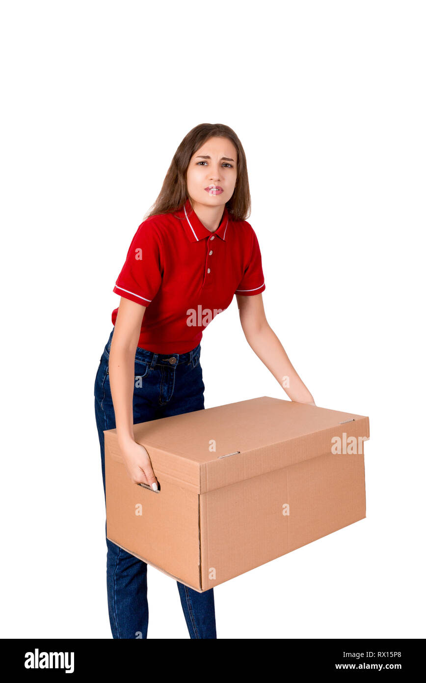 Tired delivery girl is holing a heavy parcel carton box isolated on ...