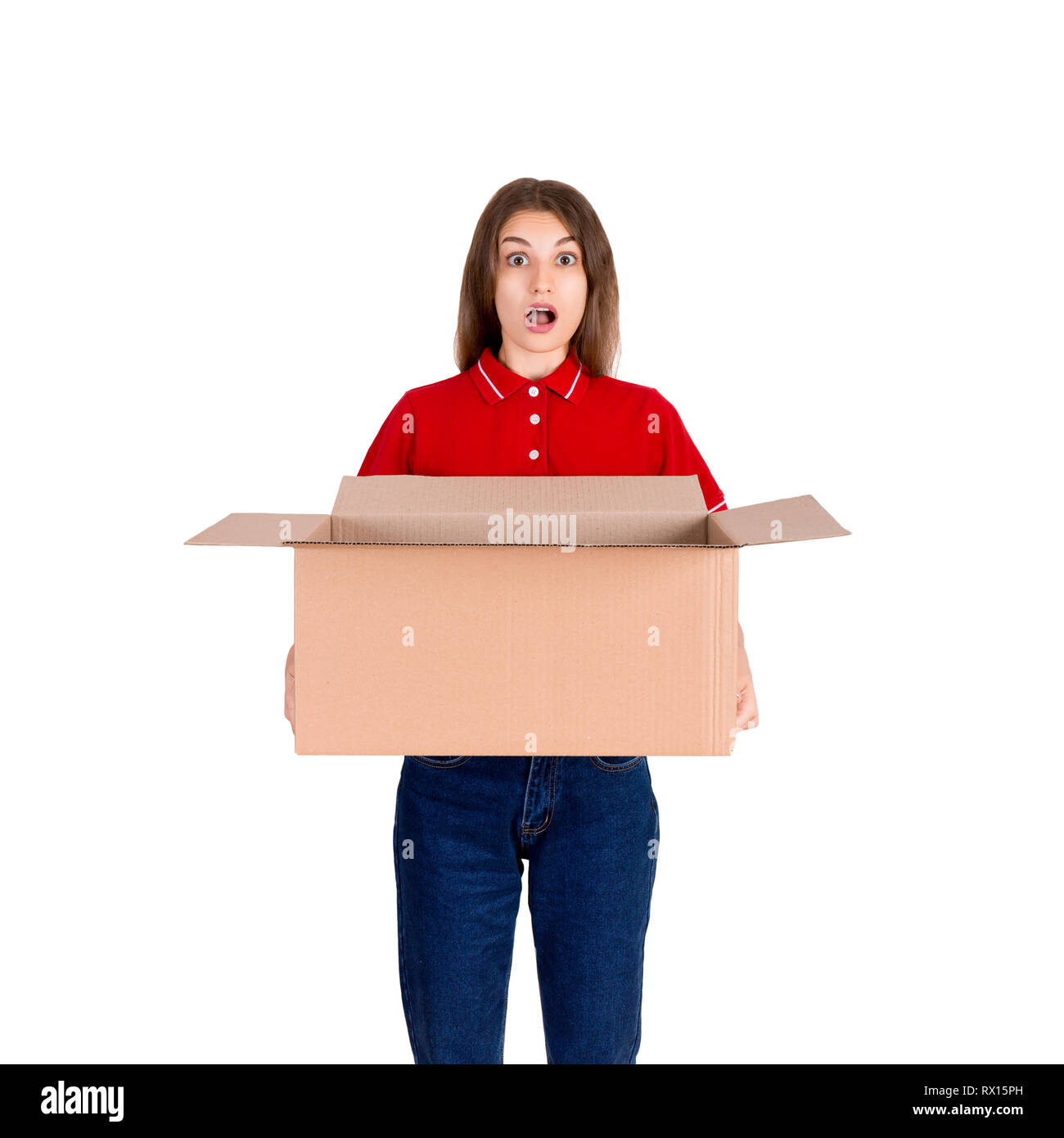Shocked delivery girl is holding a big open parcel box isolated on ...
