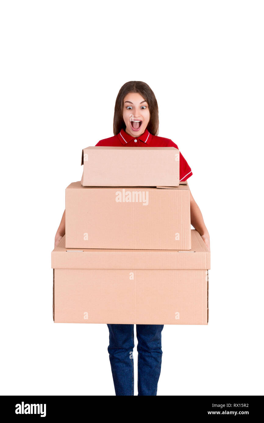 Happy young woman in red T-shirt is holding stack of big parcel boxes ...