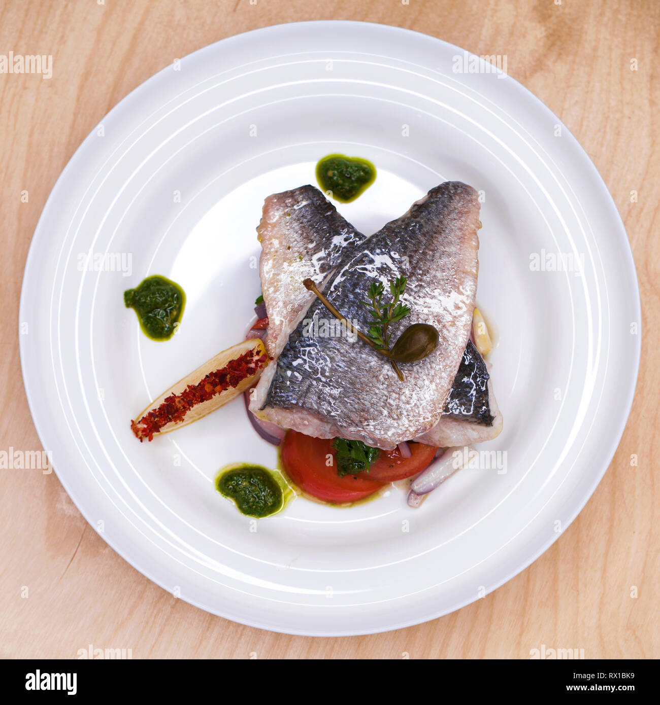 Restaurant food - Grilled Dorado fish with onion and lemon slice on ...