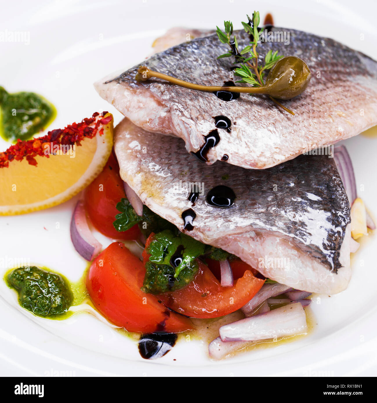 Restaurant food - Grilled Dorado fish with onion and lemon slice on ...