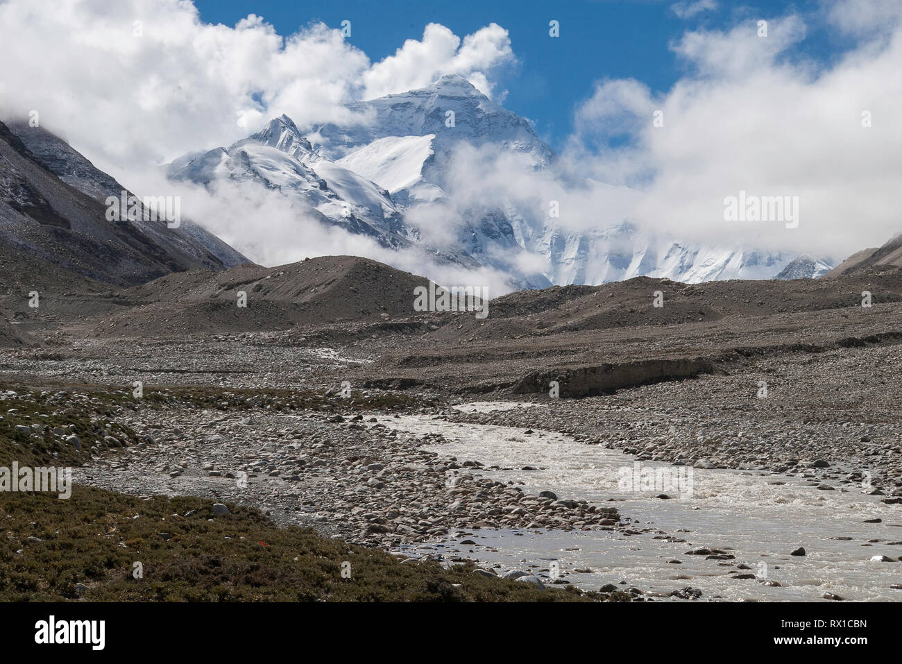 Water from melting snow and receding glacier flows in a stream near the ...