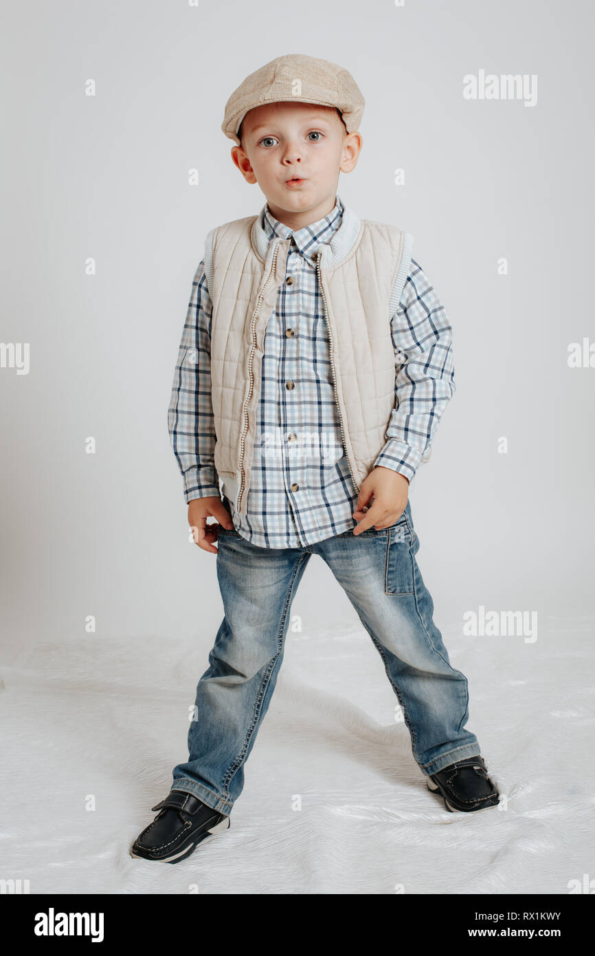 Little boy in a cap posing on a white background Stock Photo - Alamy