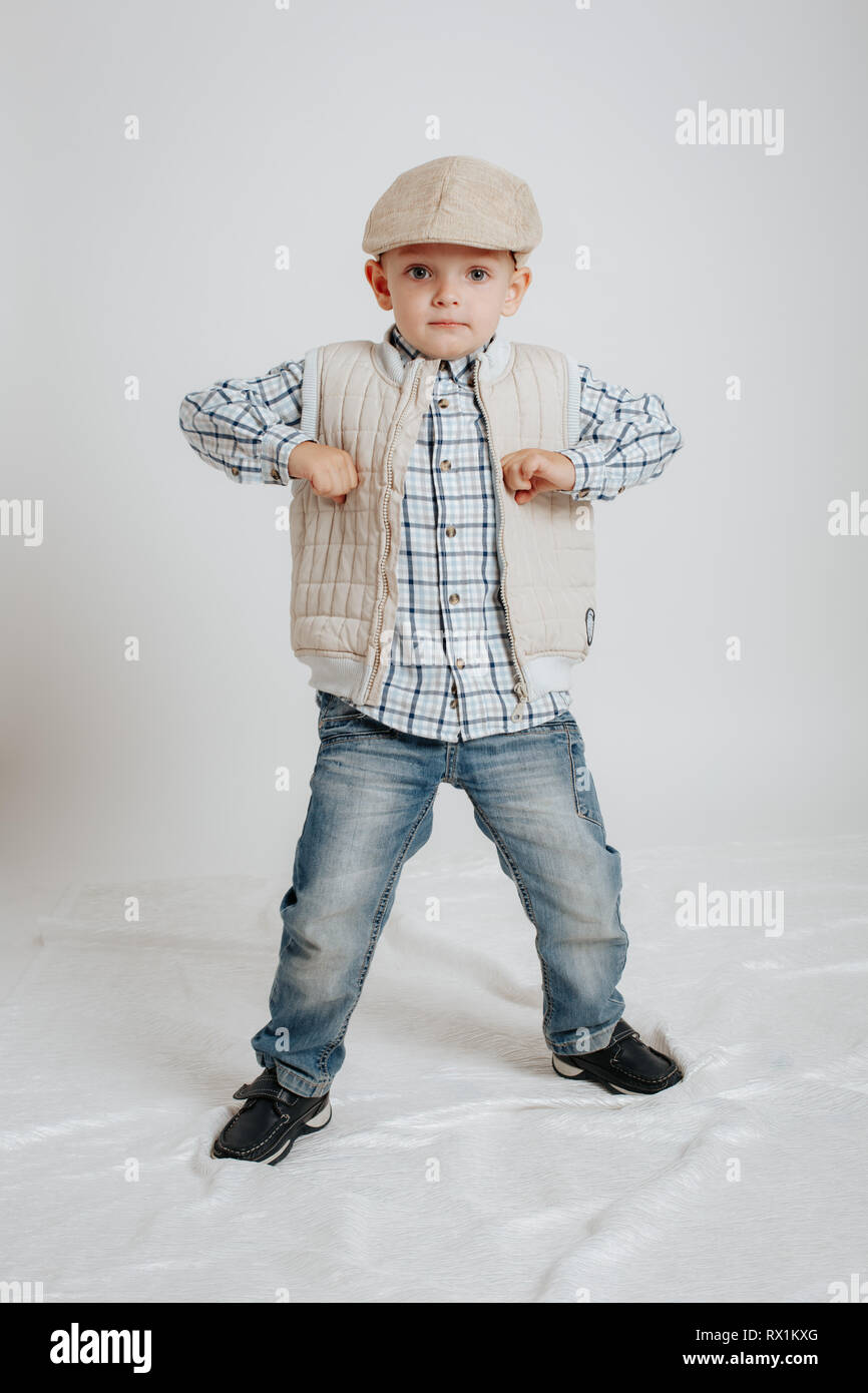 Little boy in a cap posing on a white background Stock Photo - Alamy