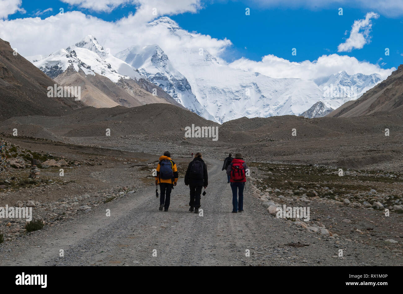 Travellers trek along a narrow road to reach the basecamp on the north ...