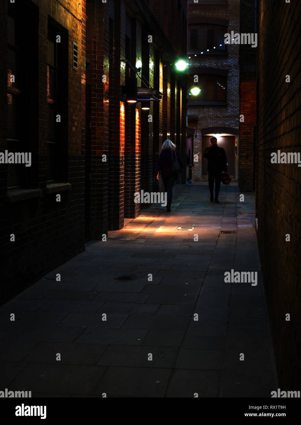 Man walking between buildings silhouette hi-res stock photography and ...