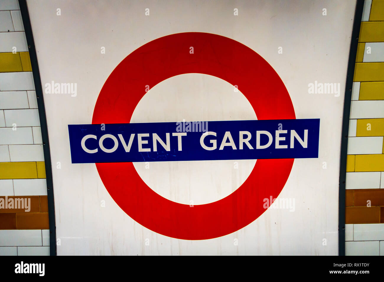 Iconic circular London Tube sign on the underground platform at Covent ...