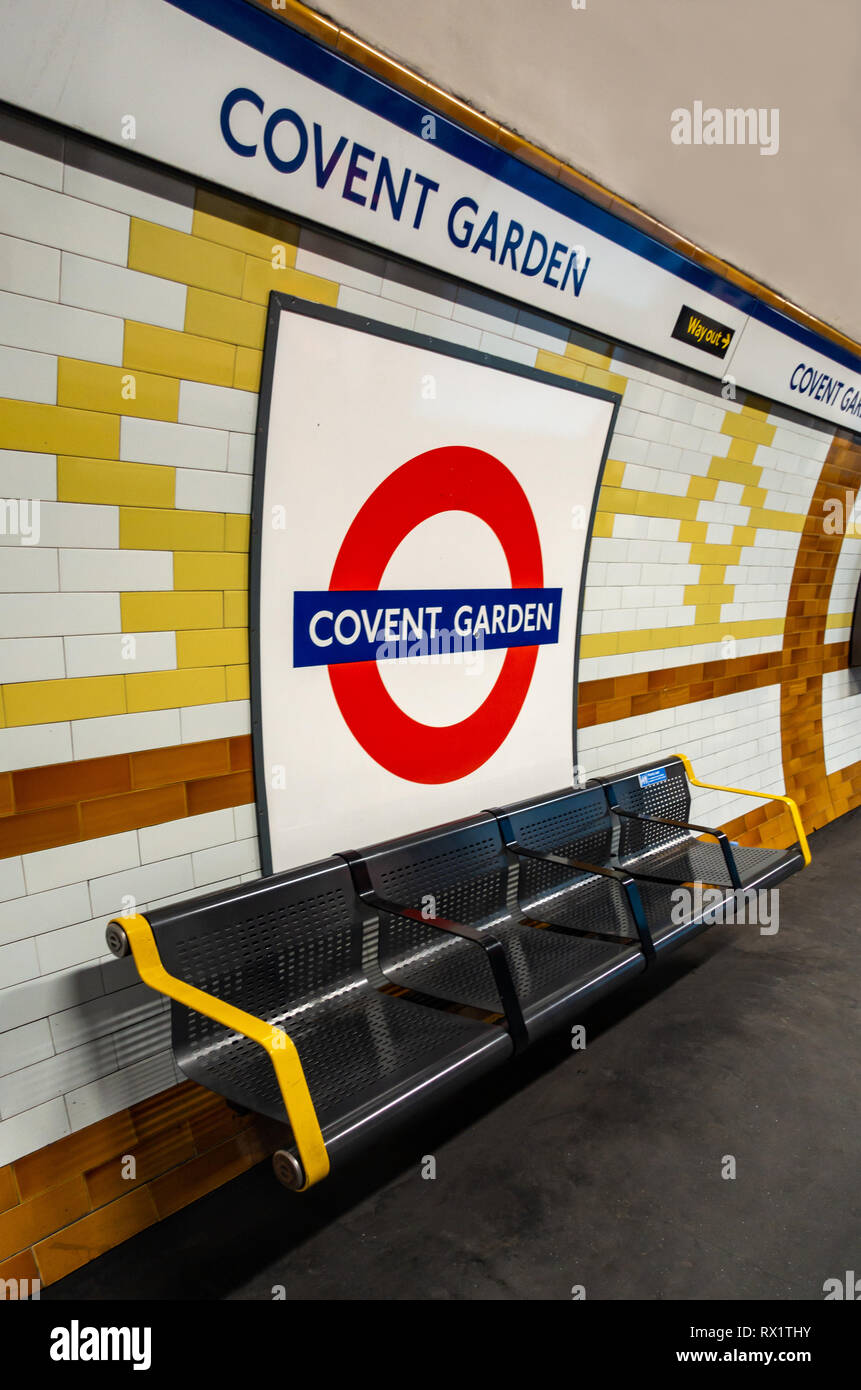 Iconic circular London Tube sign above a public Seat on the underground ...