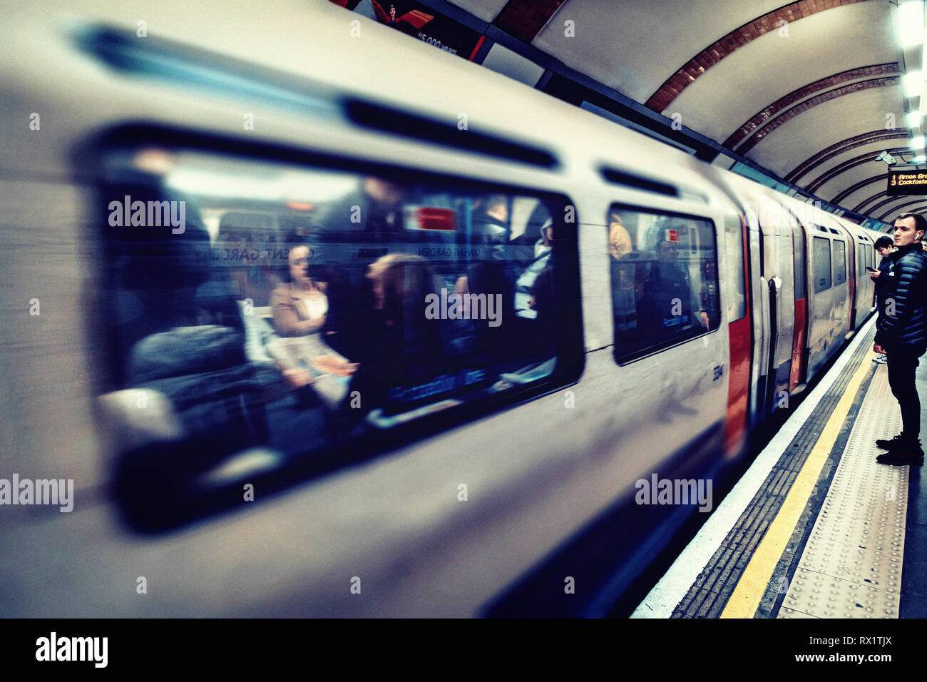 Male Commuter waits for the approaching fast moving tube train Stock ...