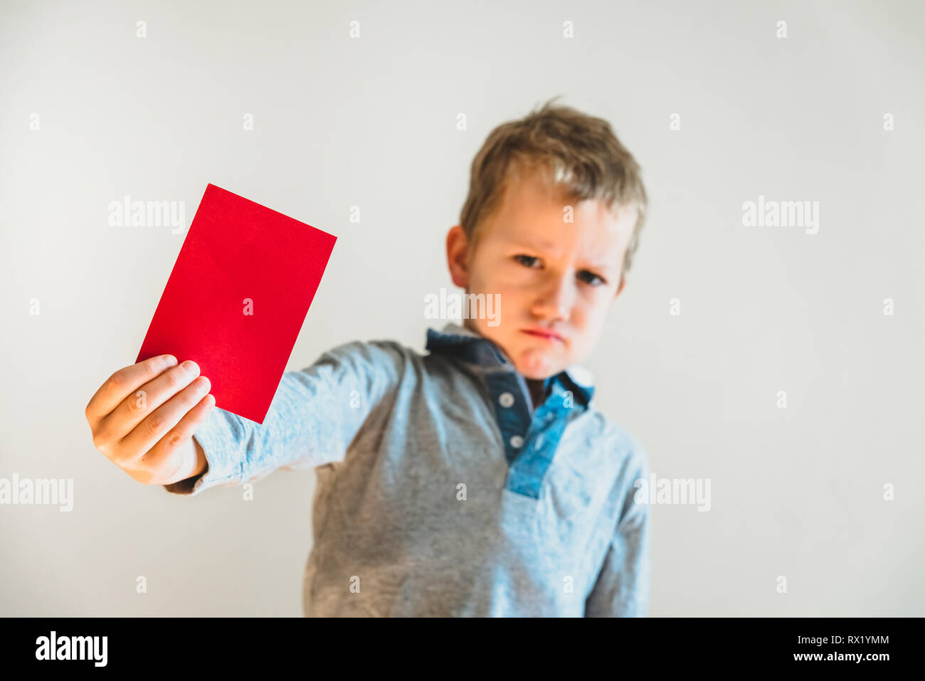 Scared child with red anti bullying card Stock Photo - Alamy