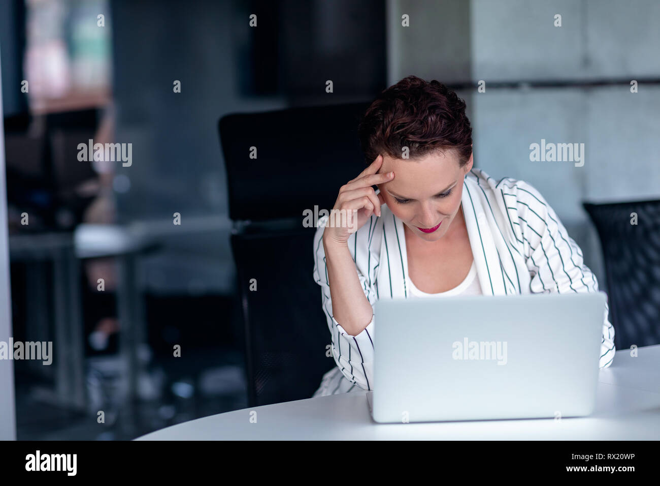 Beautiful business lady with laptop computer in office Stock Photo - Alamy