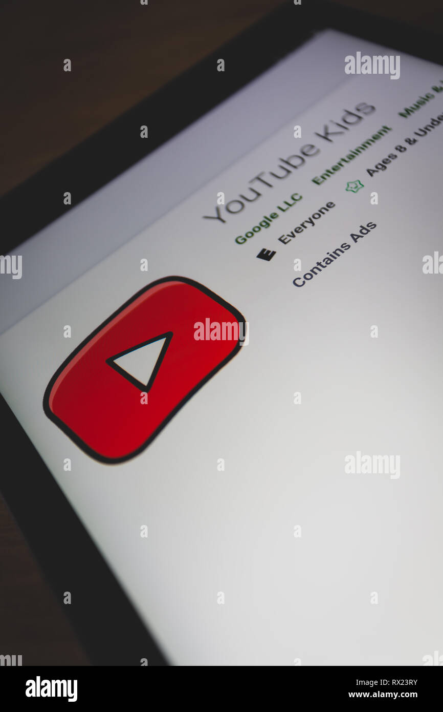 YouTube Kids app logo on Google Play store is shown on tablet screen ...