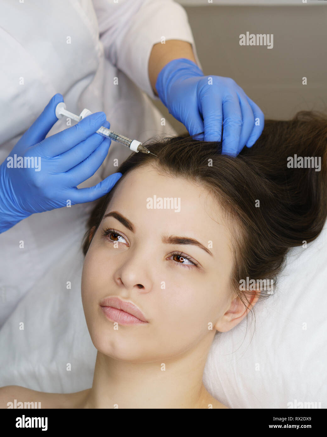 Aesthetic cosmetology. Facelift in spa salon. Beautician makes ...