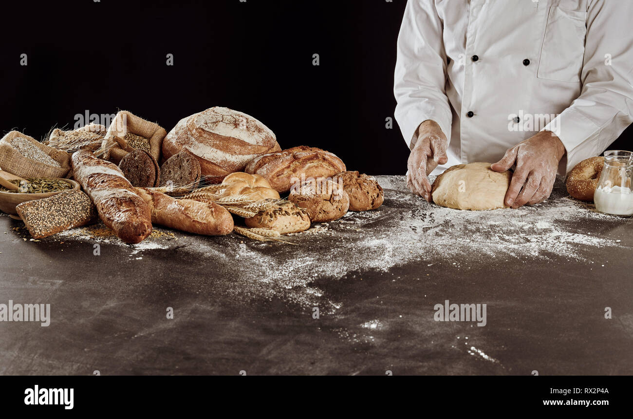 Bread preparation concept with pile of freshly baked crunchy rustic ...