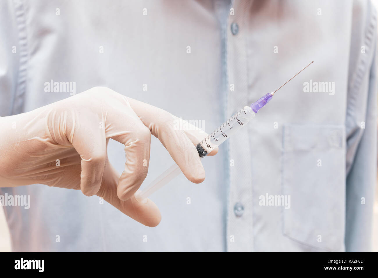 Doctor hand holding injection needle. Medical doctor picking up ...