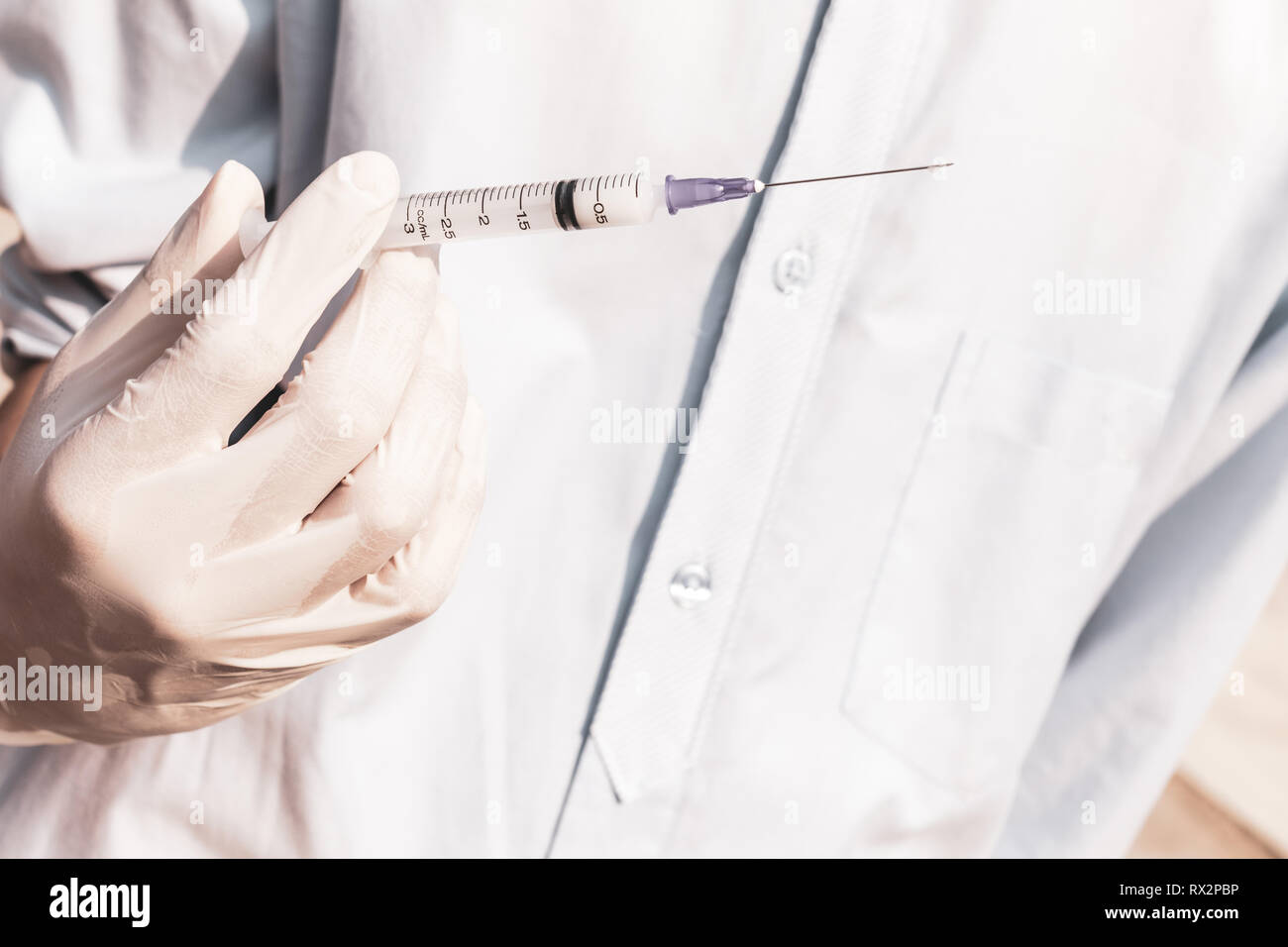 Doctor hand holding injection needle. Medical doctor picking up ...