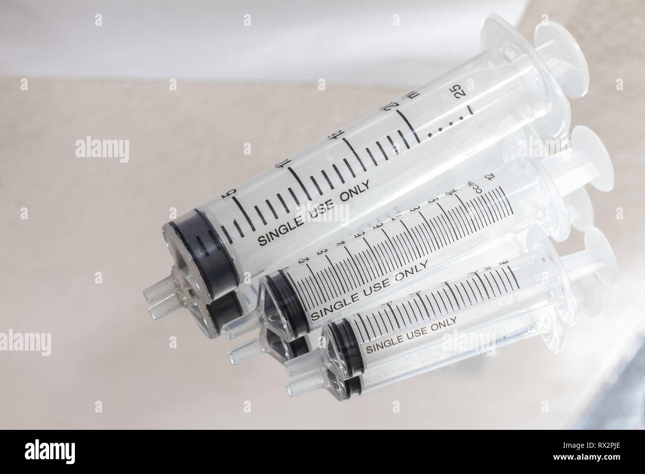 Multiple syringes or injection needle on mirror Stock Photo - Alamy