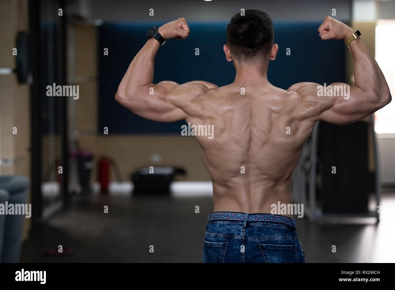 Portrait Of A Young Physically Fit Man In Jeans Showing His Well ...