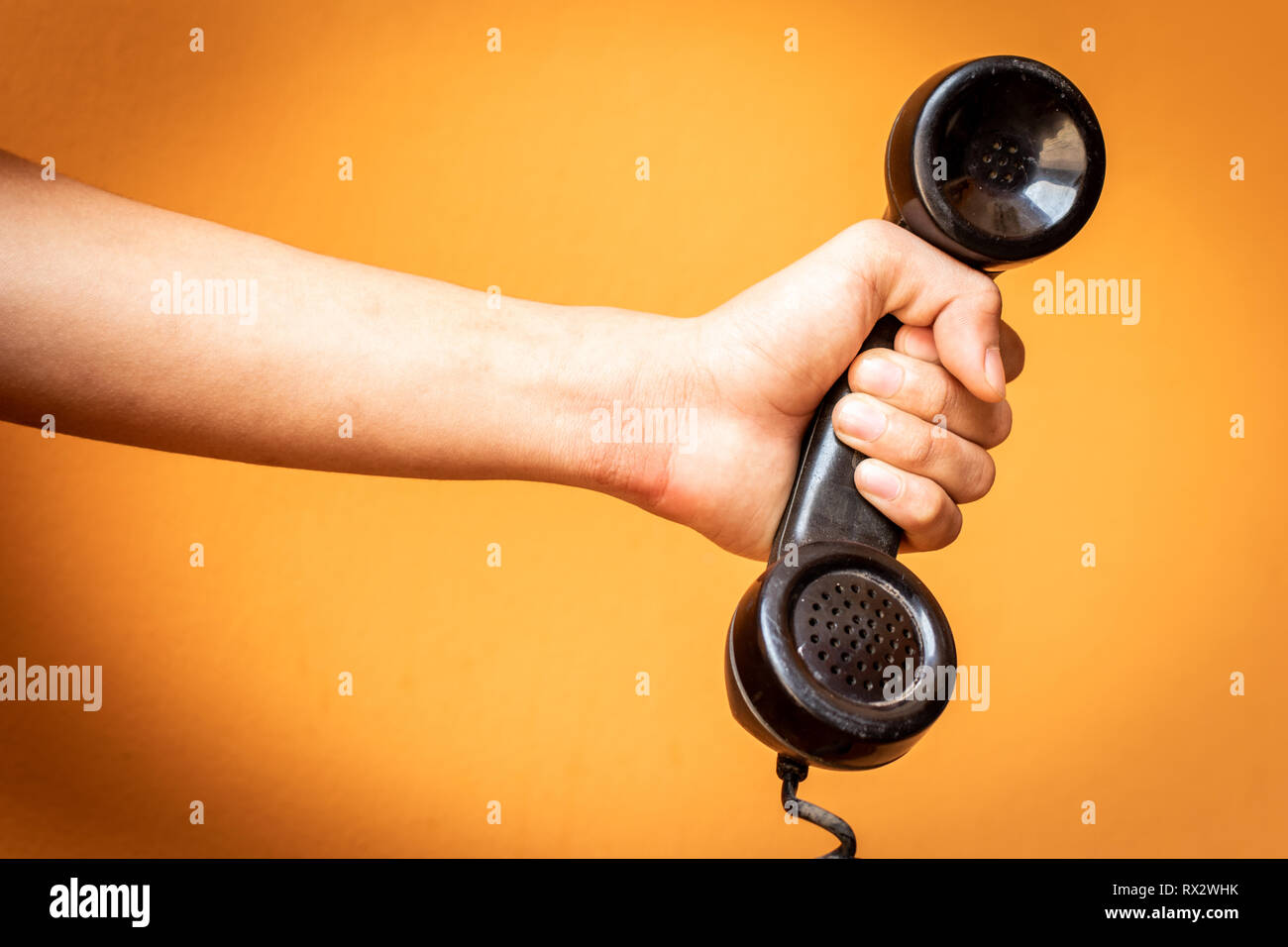 Hand holding old phone receiver hi-res stock photography and images - Alamy