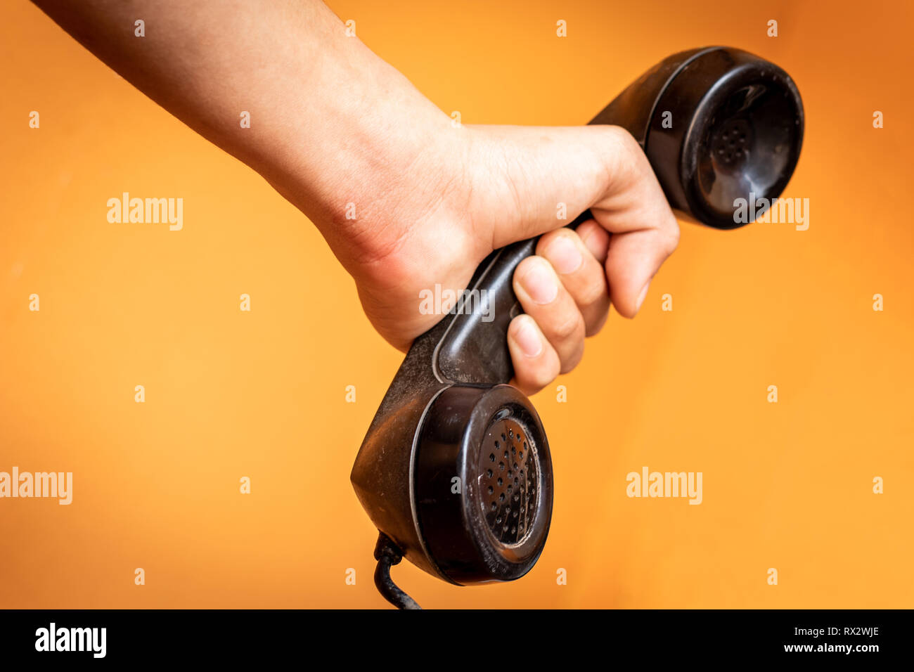 Hand holding old phone receiver hi-res stock photography and images - Alamy