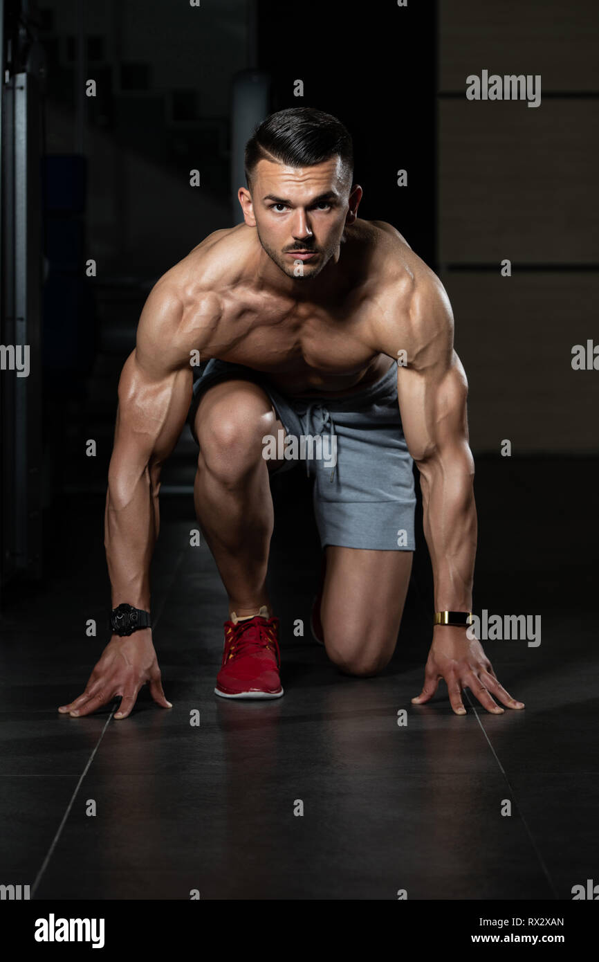 Strong Muscular Men Kneeling On The Floor - Almost Like Sprinter ...