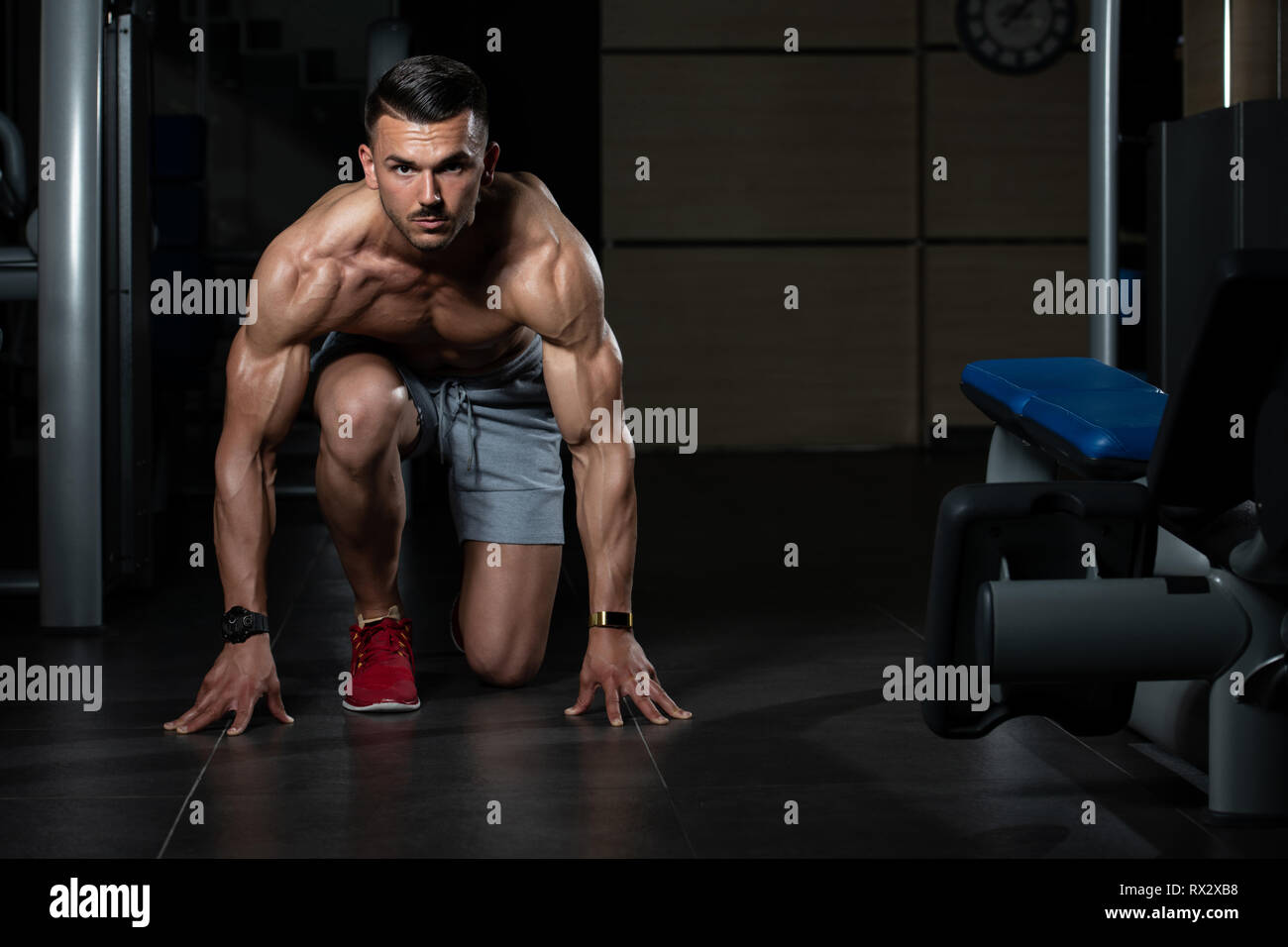 Strong Muscular Men Kneeling On The Floor - Almost Like Sprinter ...
