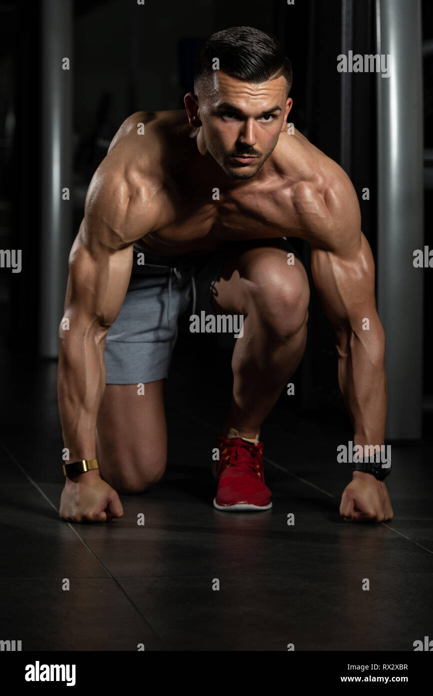 Strong Muscular Men Kneeling On The Floor - Almost Like Sprinter ...
