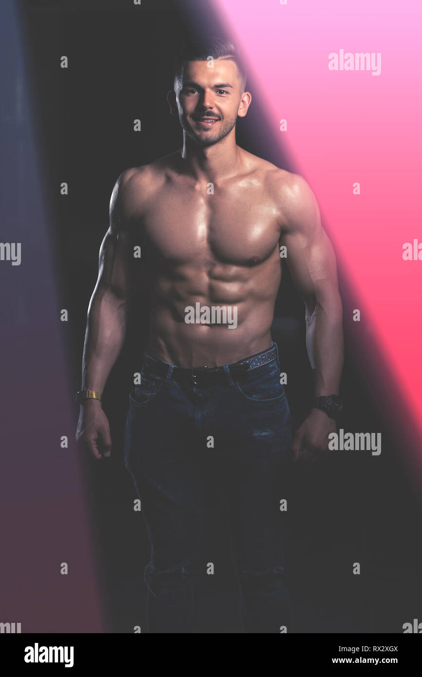 Portrait Of A Young Physically Fit Man In Jeans Showing His Well ...