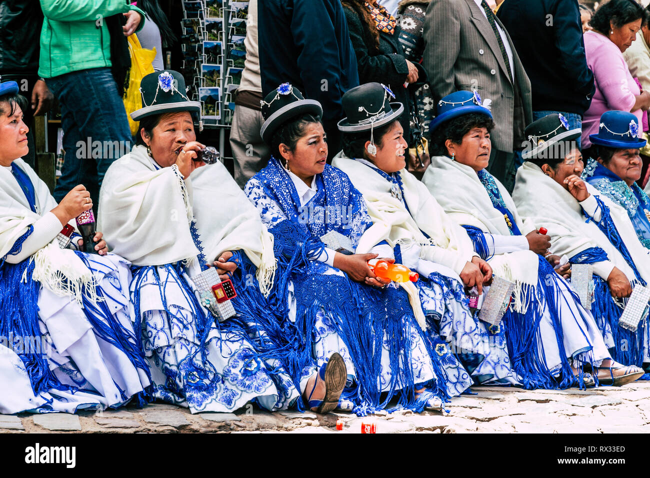 Peruvian woman in traditional blue and white clothing and black and ...