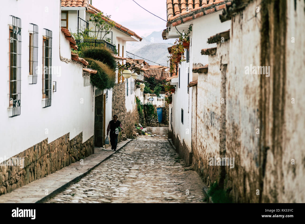 Street scene of a traditional cobblestone street and white houses ...