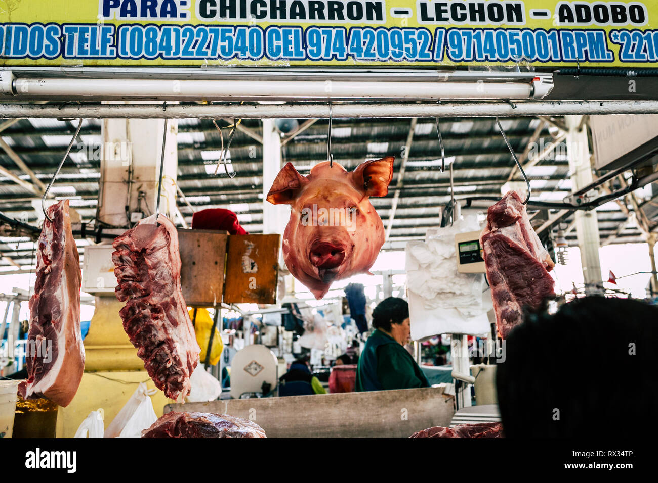 Pig head and other raw meat on display on a butcher's stall in Mercado ...