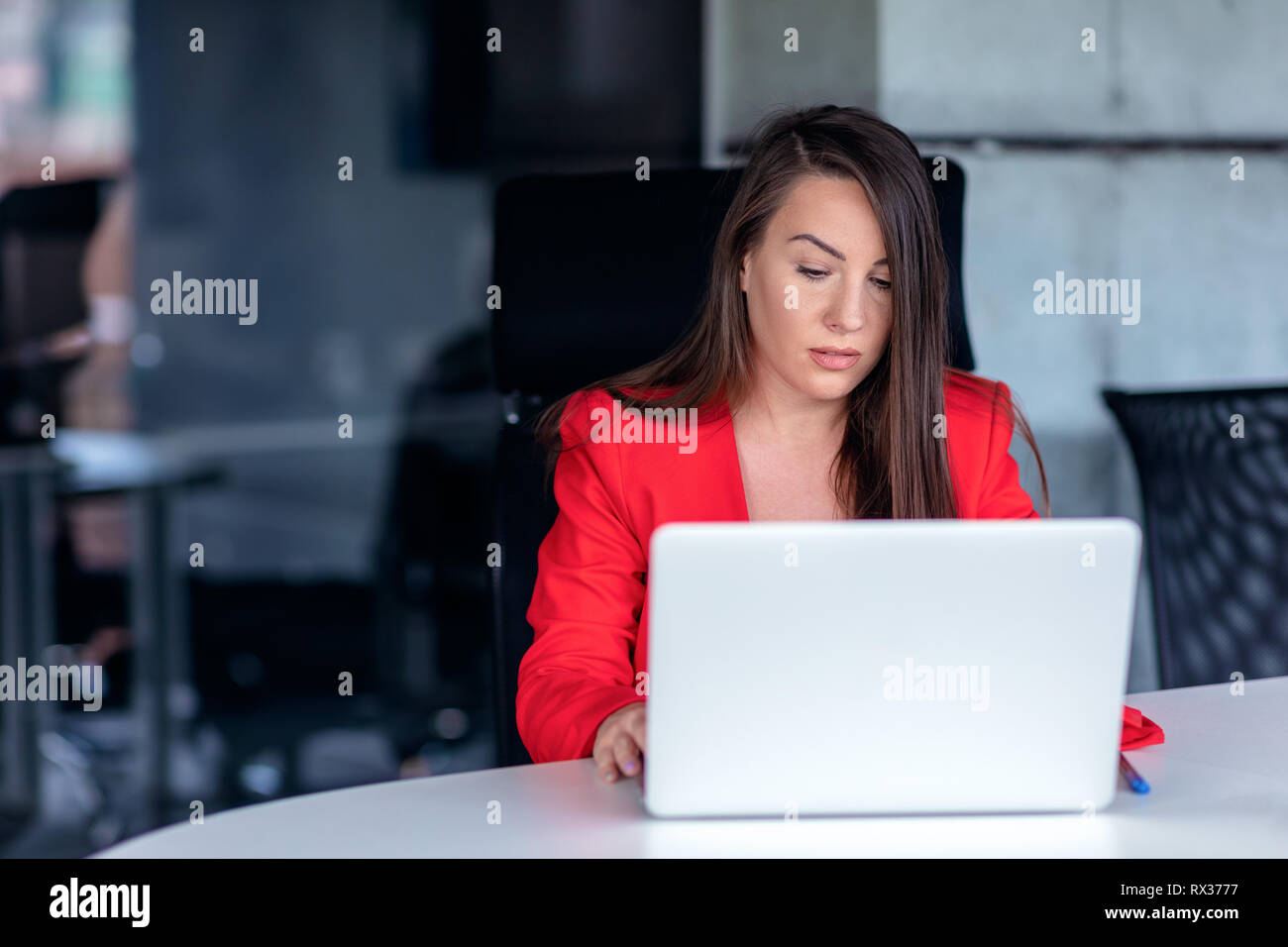 Beautiful business lady with laptop computer in office Stock Photo - Alamy