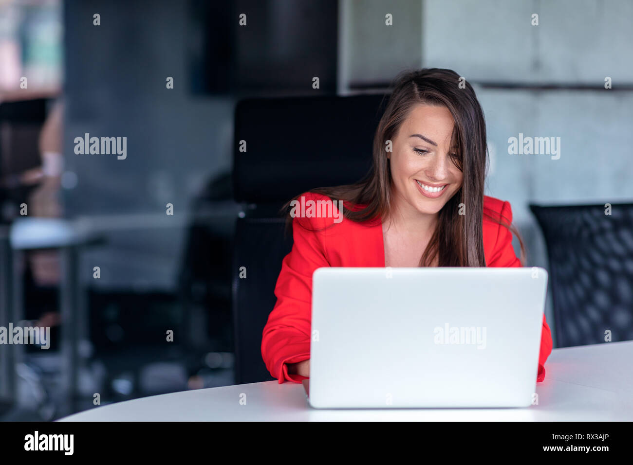 Beautiful business lady with laptop computer in office Stock Photo - Alamy