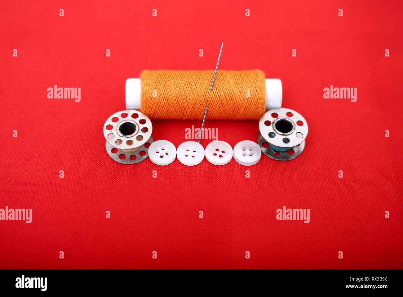 Portrait of spool thread, needle, bobbin and button. Isolated on the ...