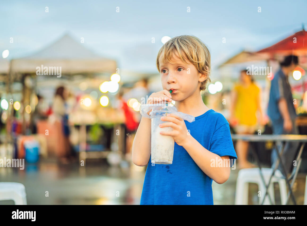 Young boy tourist on Walking street Asian food market Stock Photo - Alamy