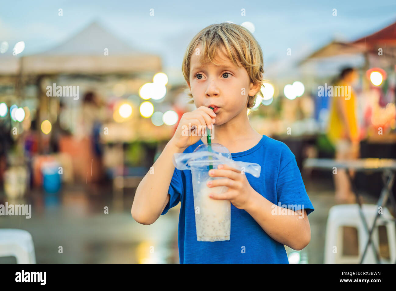 Young boy tourist on Walking street Asian food market Stock Photo - Alamy