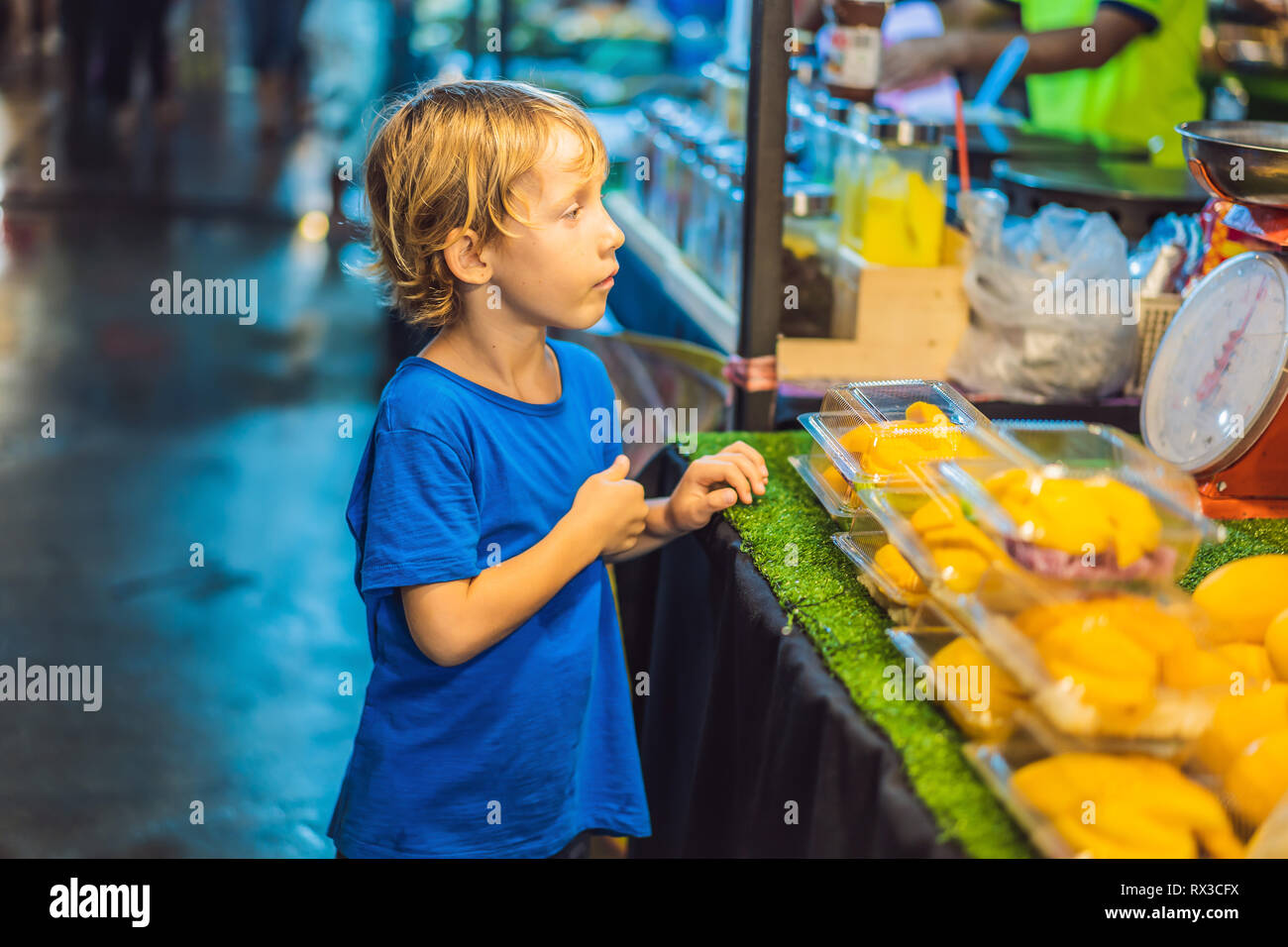 Young boy tourist on Walking street Asian food market Stock Photo - Alamy