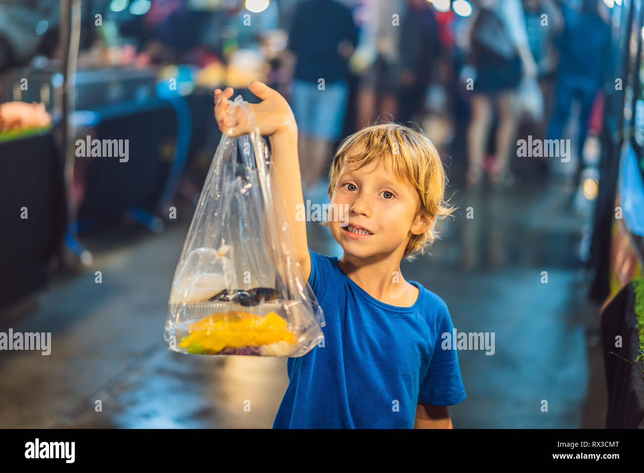 Young boy tourist on Walking street Asian food market Stock Photo - Alamy