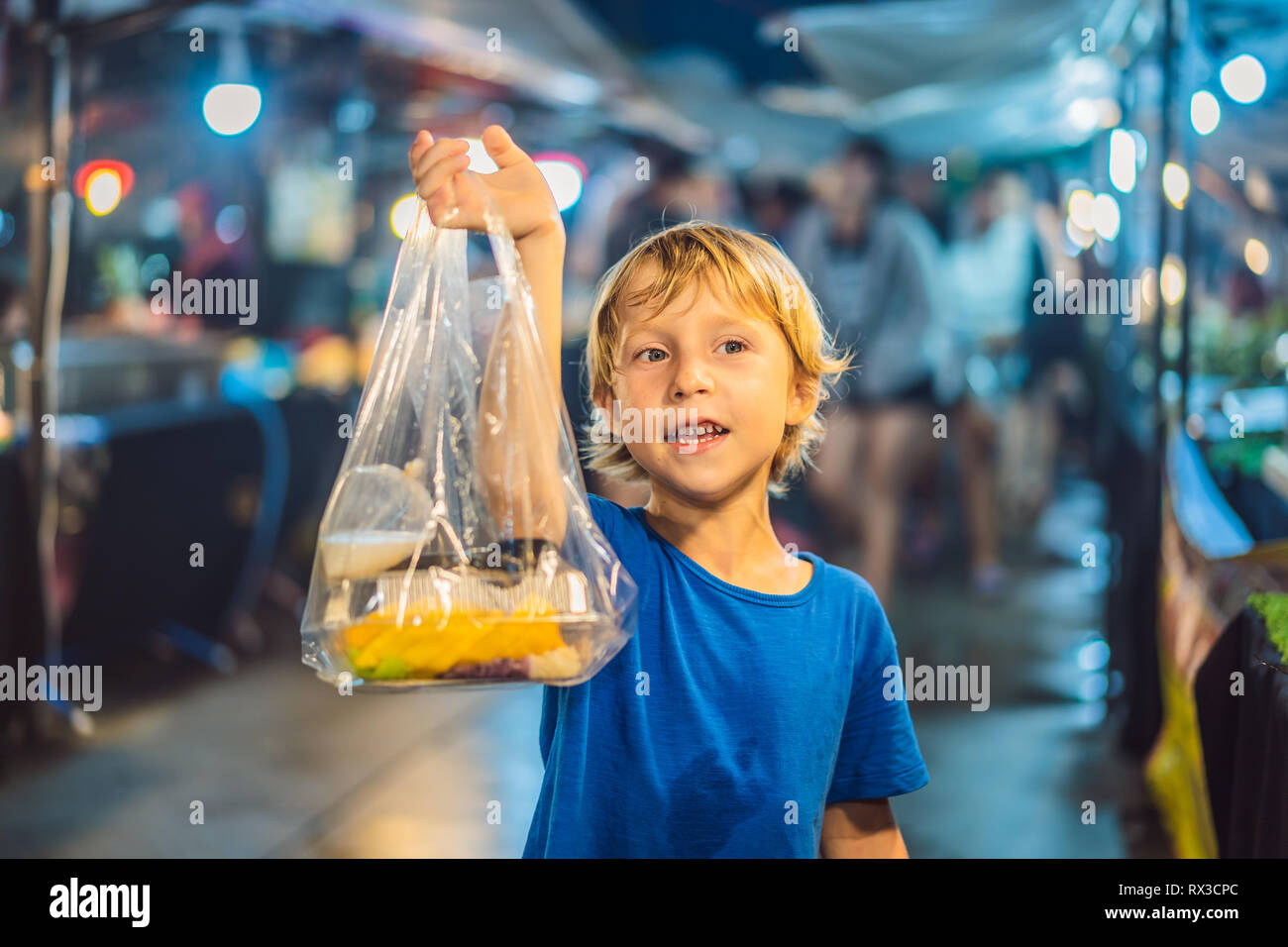 Young boy tourist on Walking street Asian food market Stock Photo - Alamy