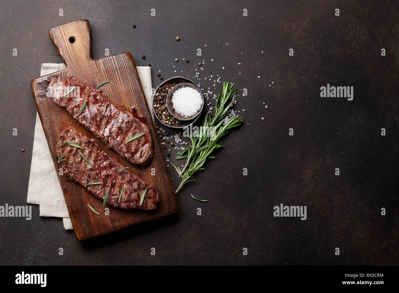 Top blade or denver grilled steak over cutting board. Top view with ...