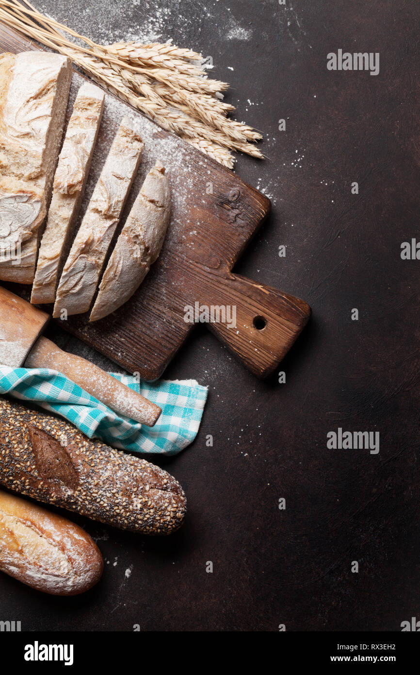 Homemade crusty bread cooking on stone table. Top view with space for ...