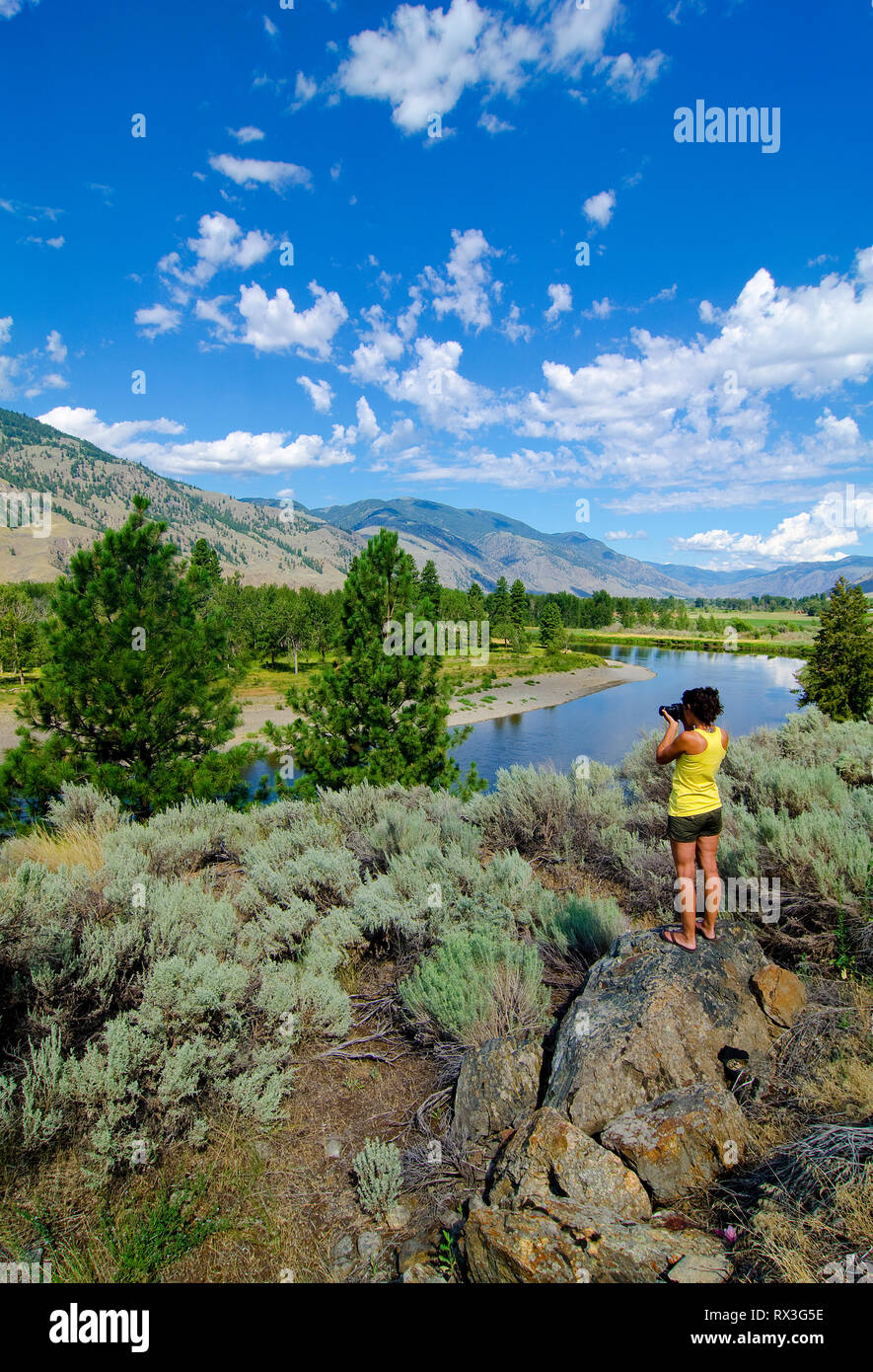 Women takes photos along the similkameen river near cawston hi-res ...