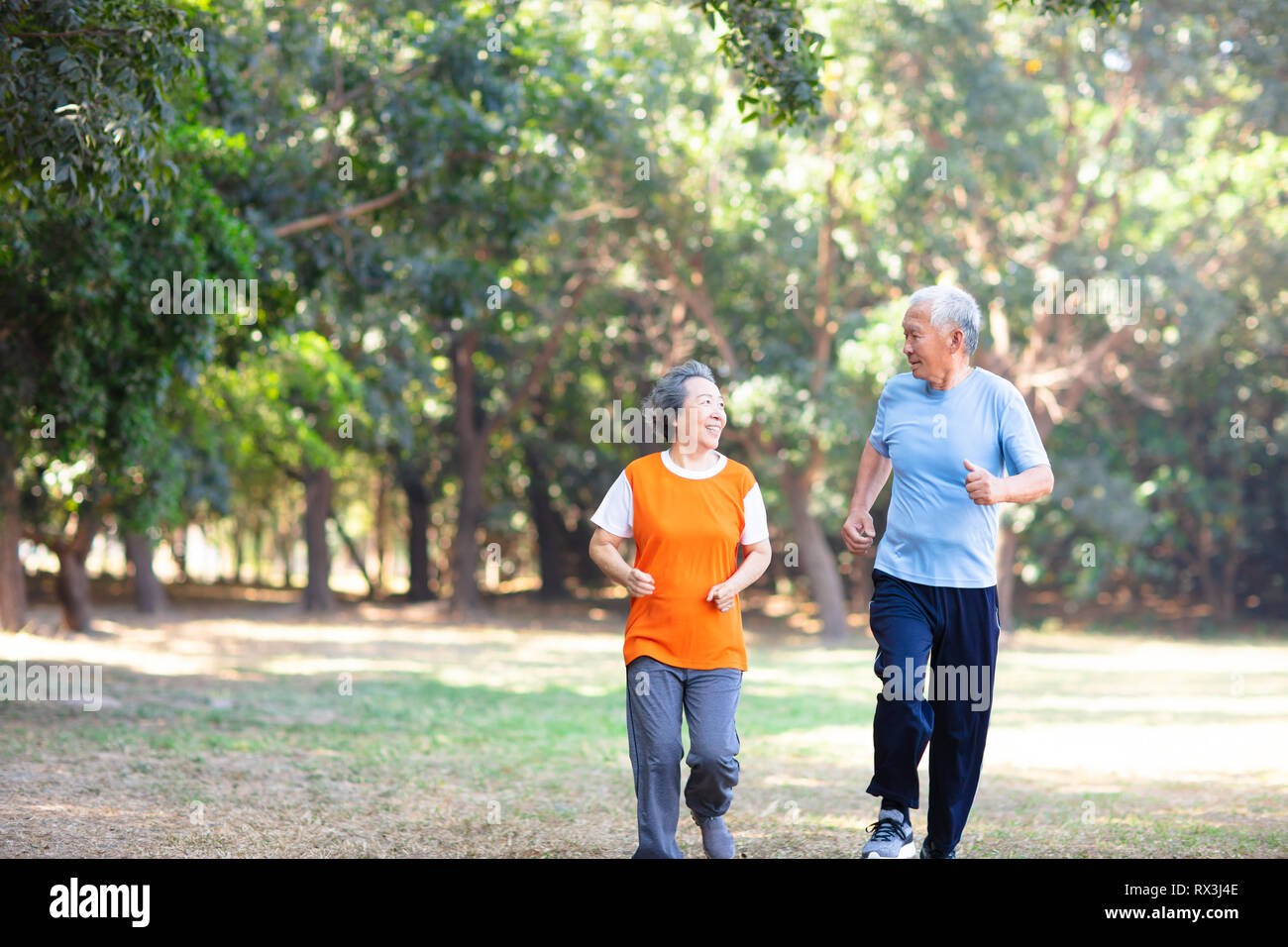 Happy mature chinese couple running hi-res stock photography and images - Alamy