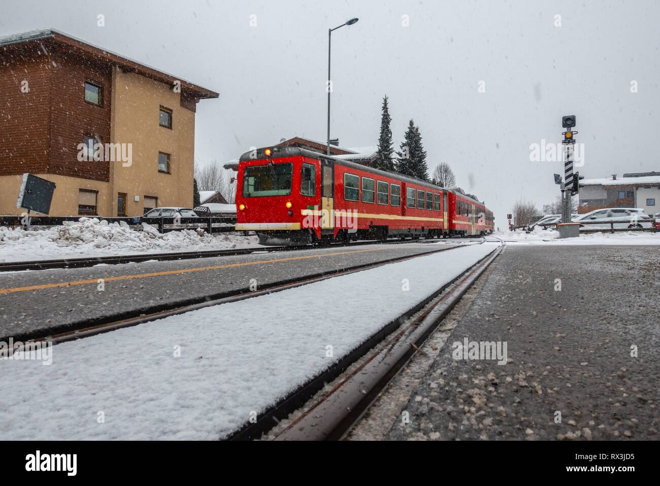 a red train enters the station Stock Photo - Alamy