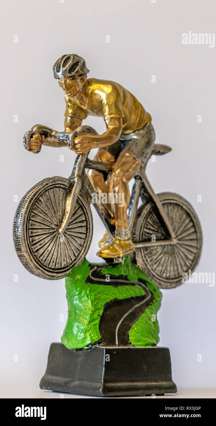 a sports trophy stands in front of a white wall Stock Photo - Alamy
