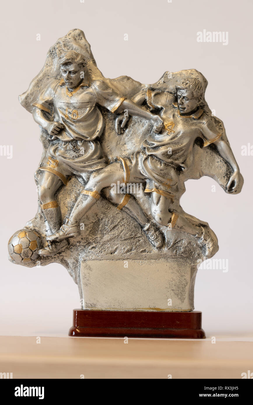 a sports trophy stands in front of a white wall Stock Photo - Alamy